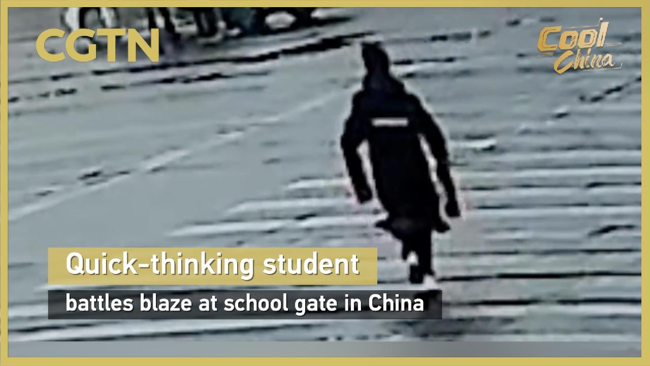 Quick-thinking student battles blaze at school gate in China - CGTN