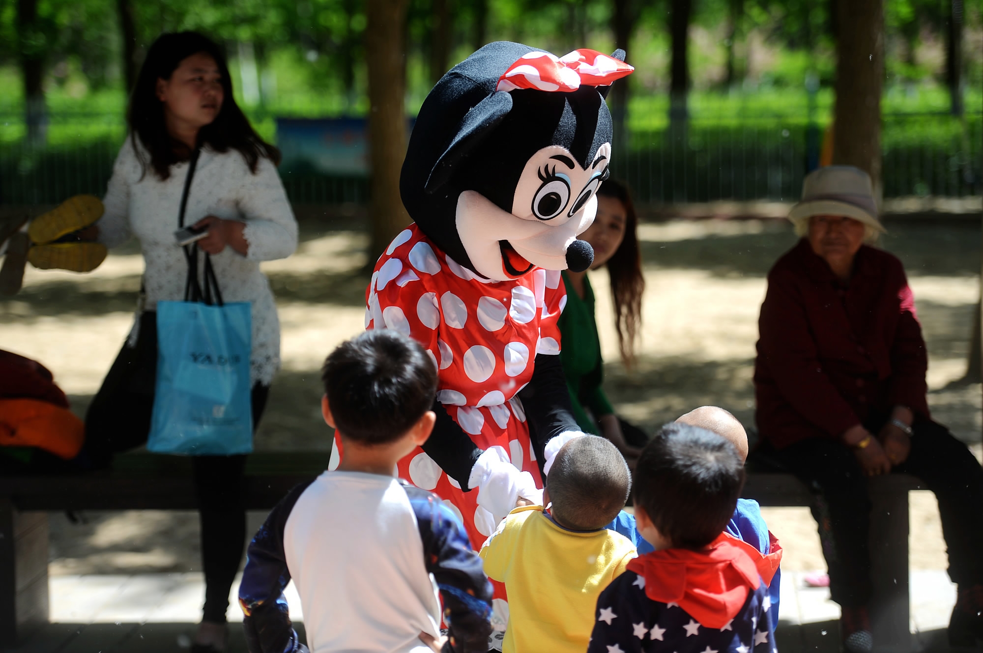 Old woman wears Mickey Mouse costume to pay relative's medical bills - CGTN